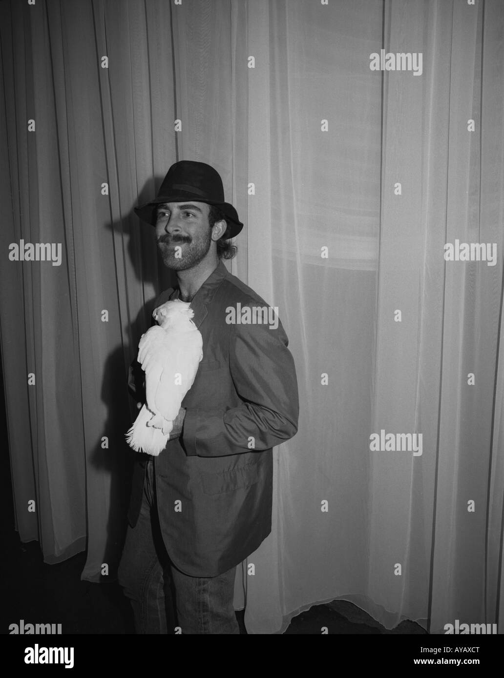 man with bird in night club Stock Photo - Alamy