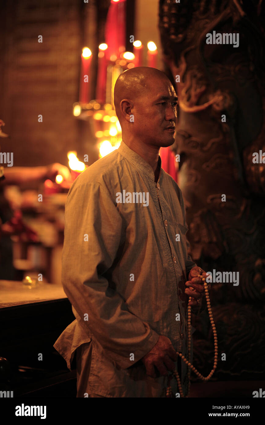 Taiwan Taipei Buddhist monk with shaved head at prayer inside Long Sham ...
