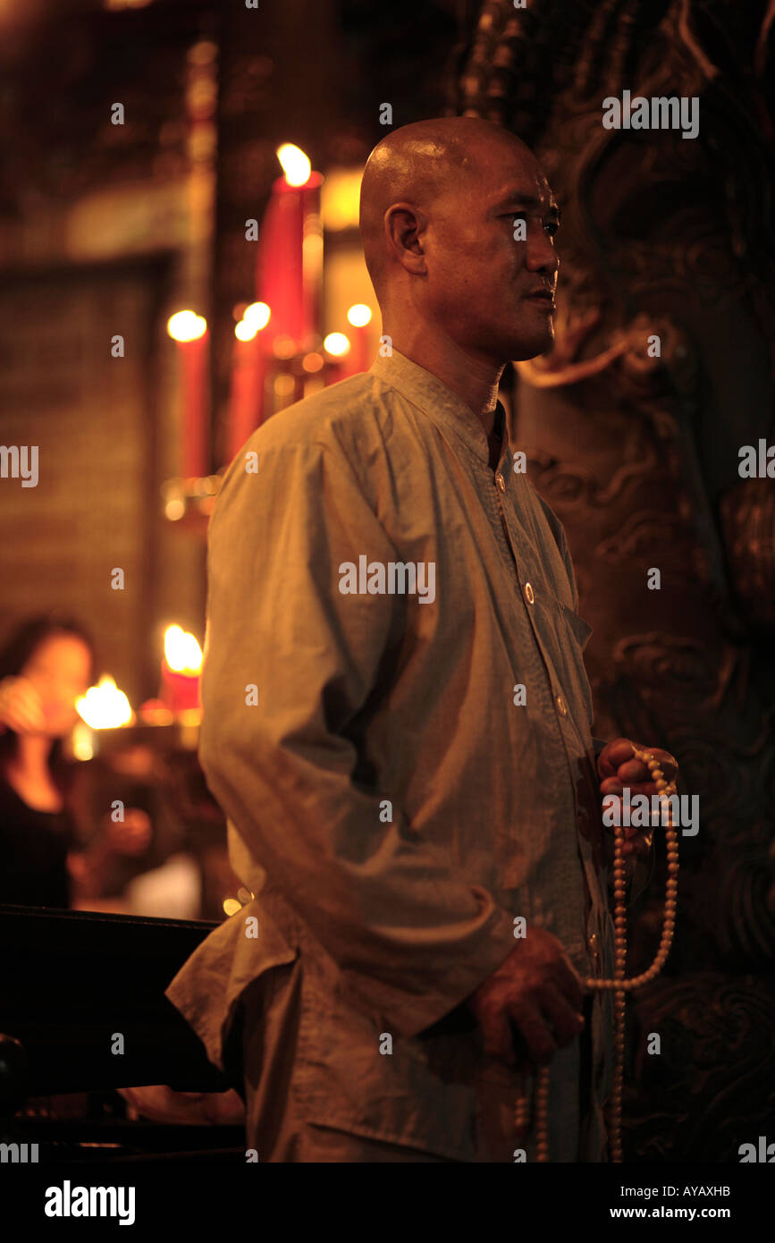 Taiwan Taipei Buddhist monk with shaved head at prayer inside Long Sham ...