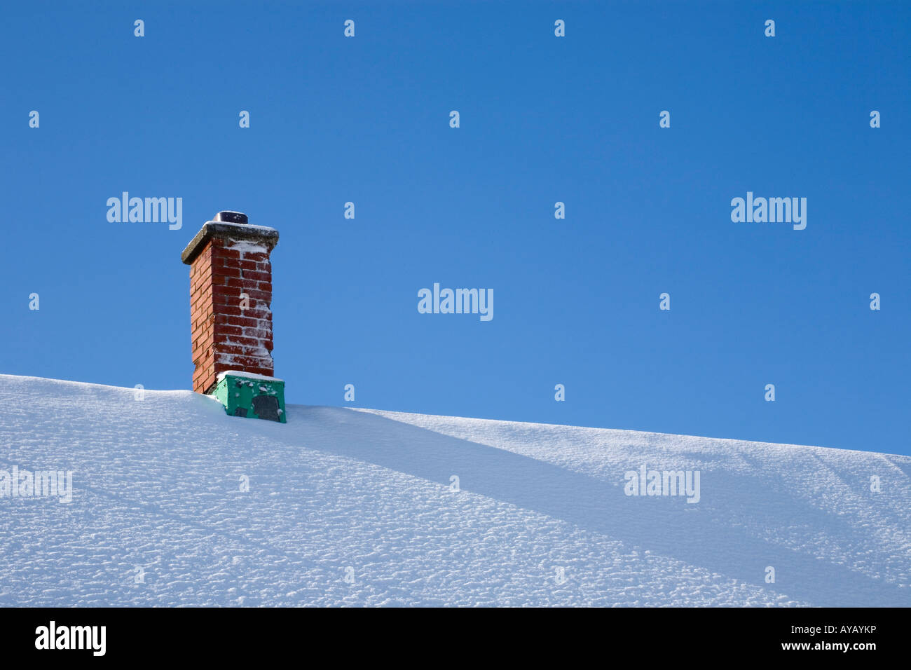 Chimney on a snowy roof Stock Photo - Alamy