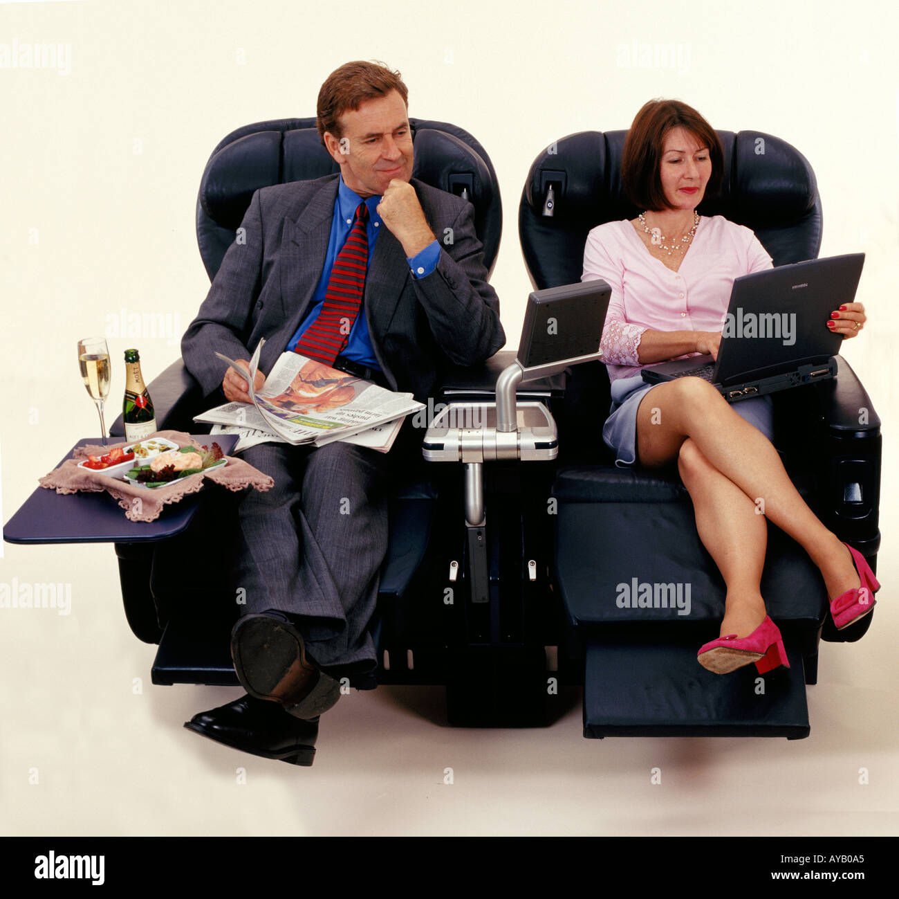 Business Executives traveling ,and using Laptops ..sitting in First ...