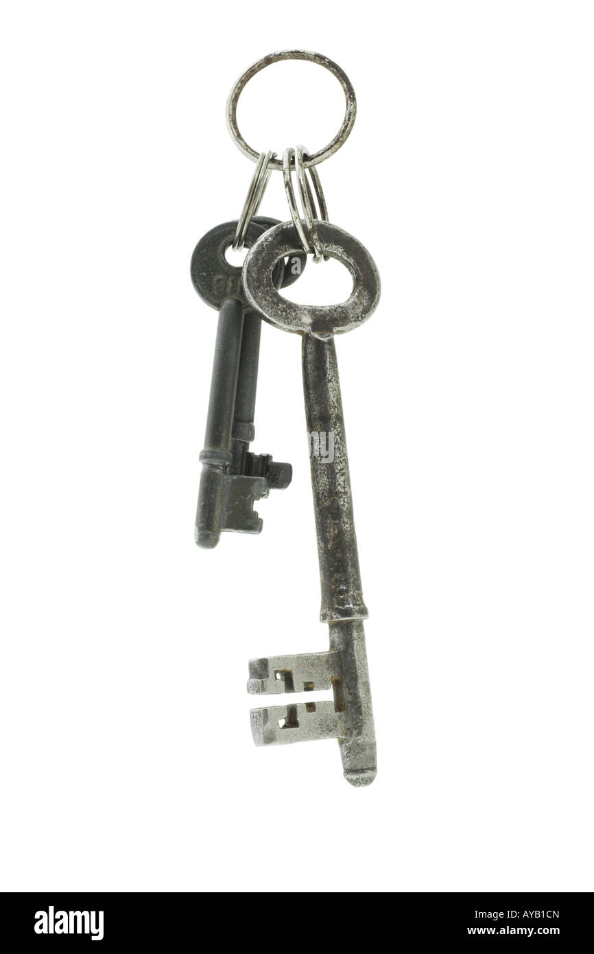 Assorted sizes of old keys suspended in the air on white background ...