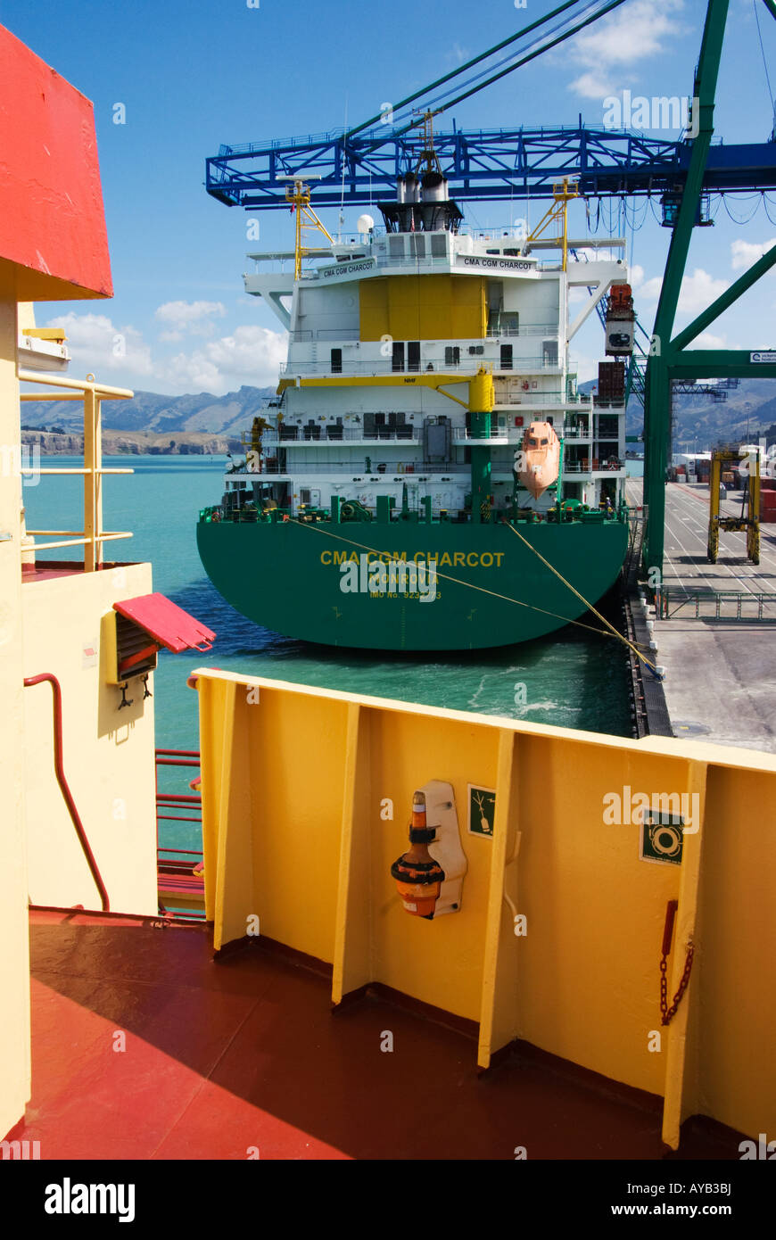 Shipping alongside the quay with a crane working containers Stock Photo ...