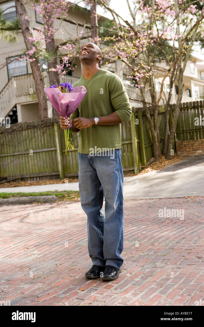 Romantic young man presenting flowers hi-res stock photography and ...