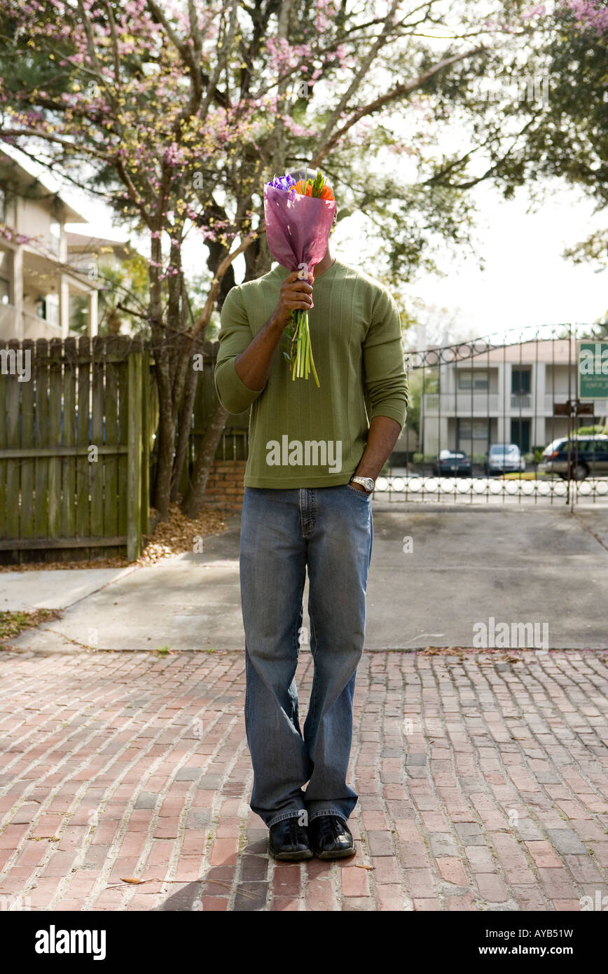 Man holding flowers in front of face hi-res stock photography and ...