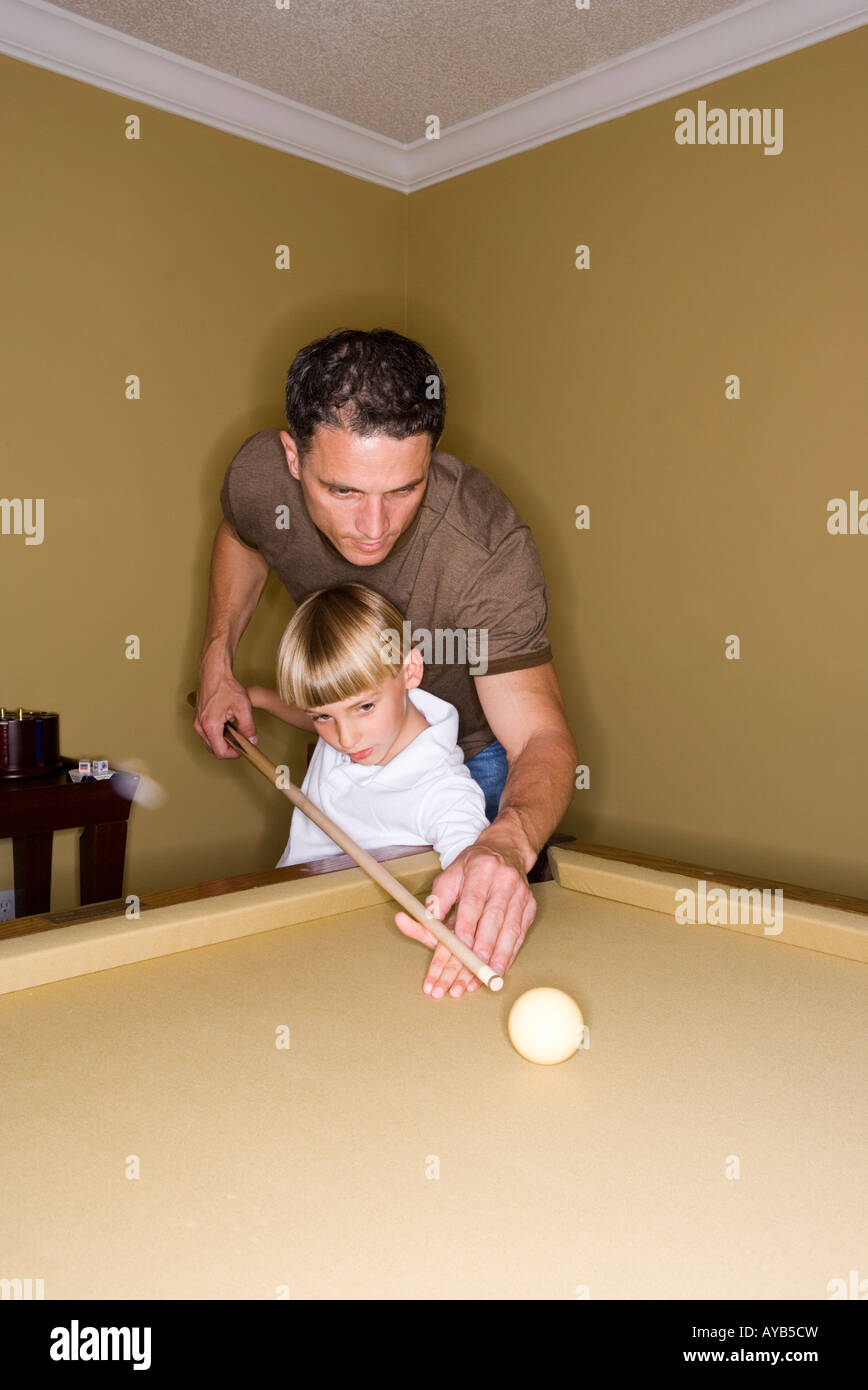 Father showing his young son how to play pool Stock Photo - Alamy