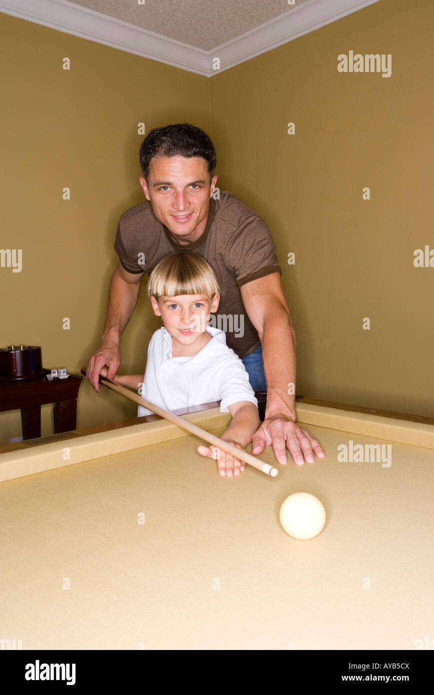 Father showing his young son how to play pool Stock Photo - Alamy