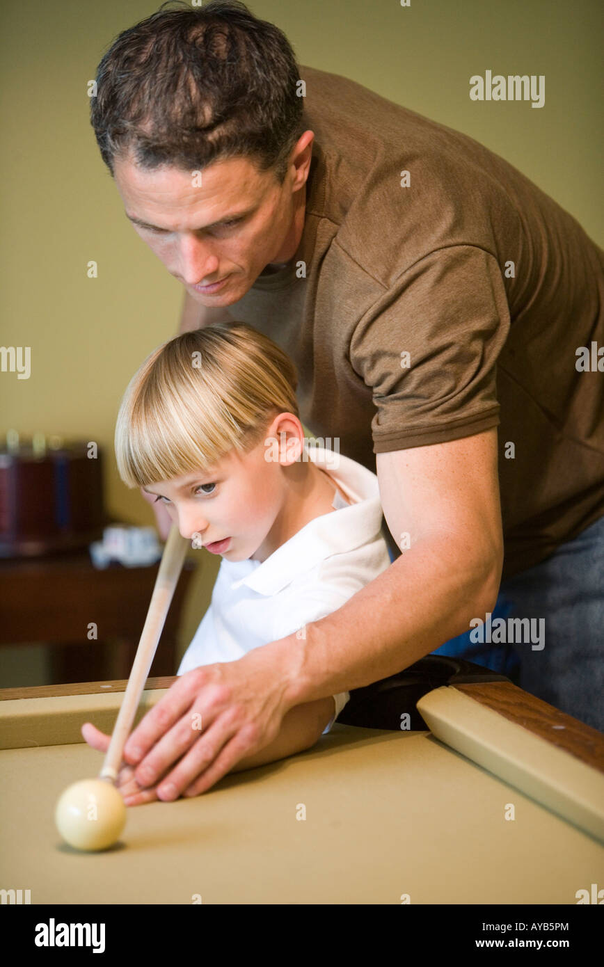 Father showing his young son how to shoot pool Stock Photo - Alamy