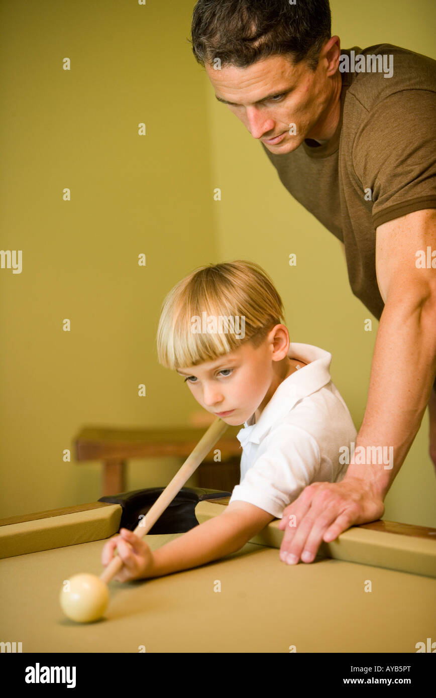 Father showing his young son how to shoot pool Stock Photo - Alamy