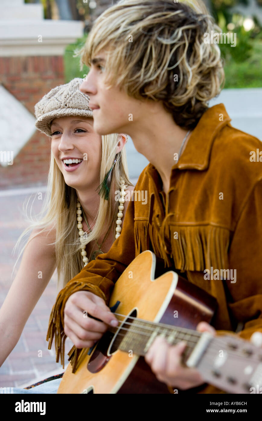 Hippie couple playing guitar Stock Photo - Alamy