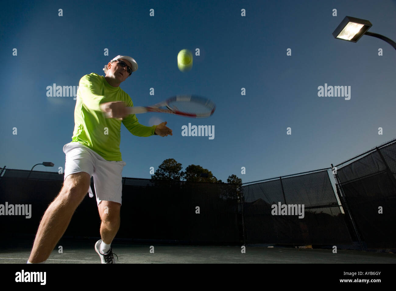 Tennis player hitting a backhand Stock Photo - Alamy