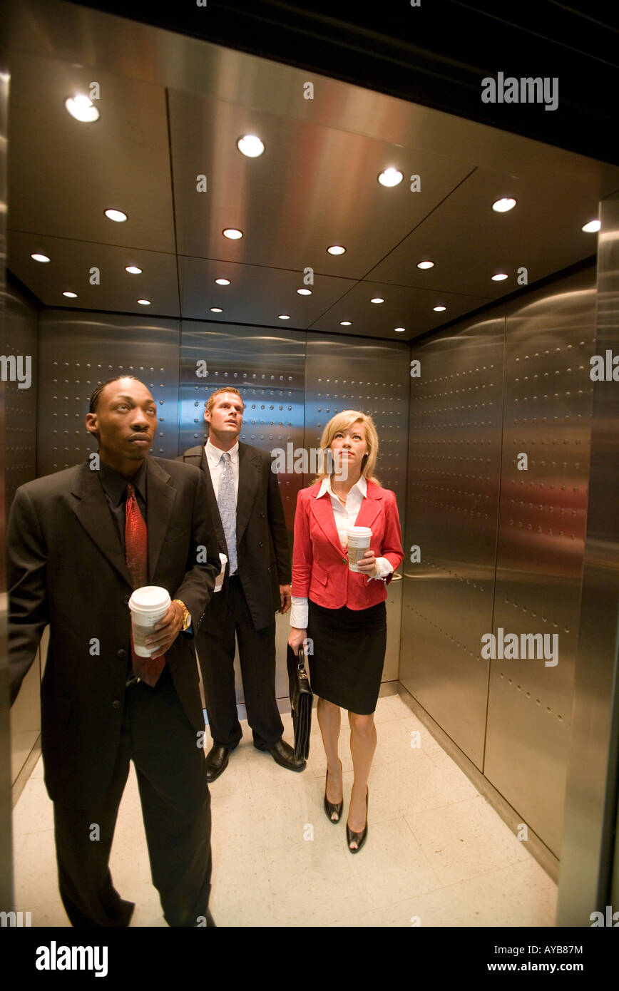 Portrait of business people riding in an elevator Stock Photo - Alamy