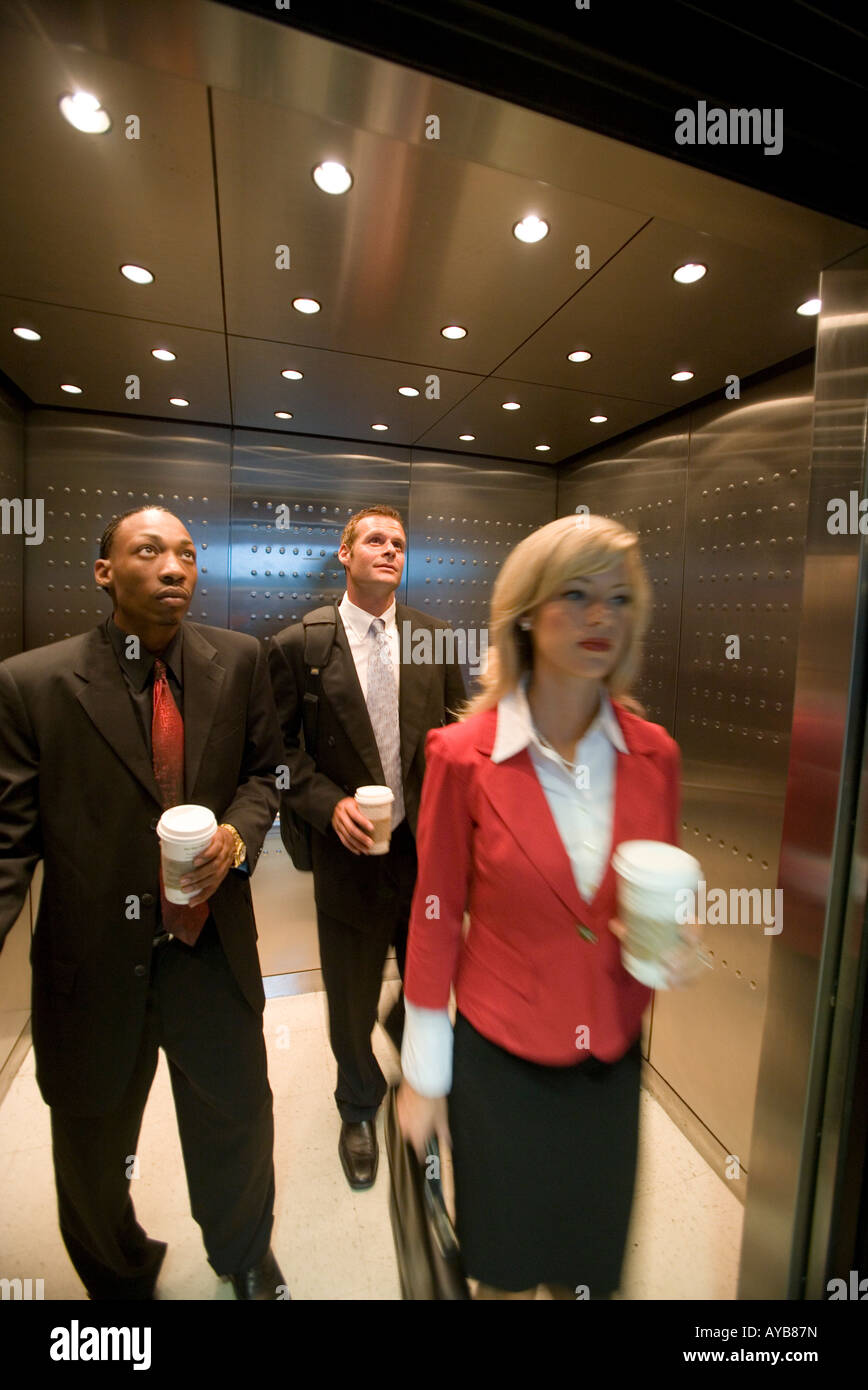 Portrait of business people riding in an elevator Stock Photo - Alamy