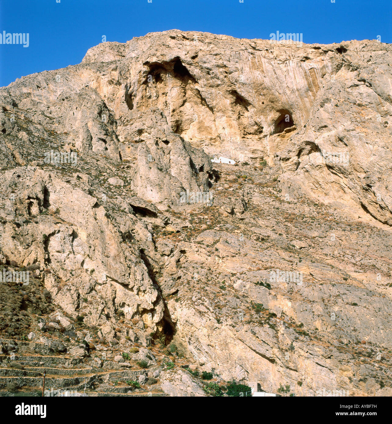 Church on the side of the cliff above the coastal town of Perissa in ...