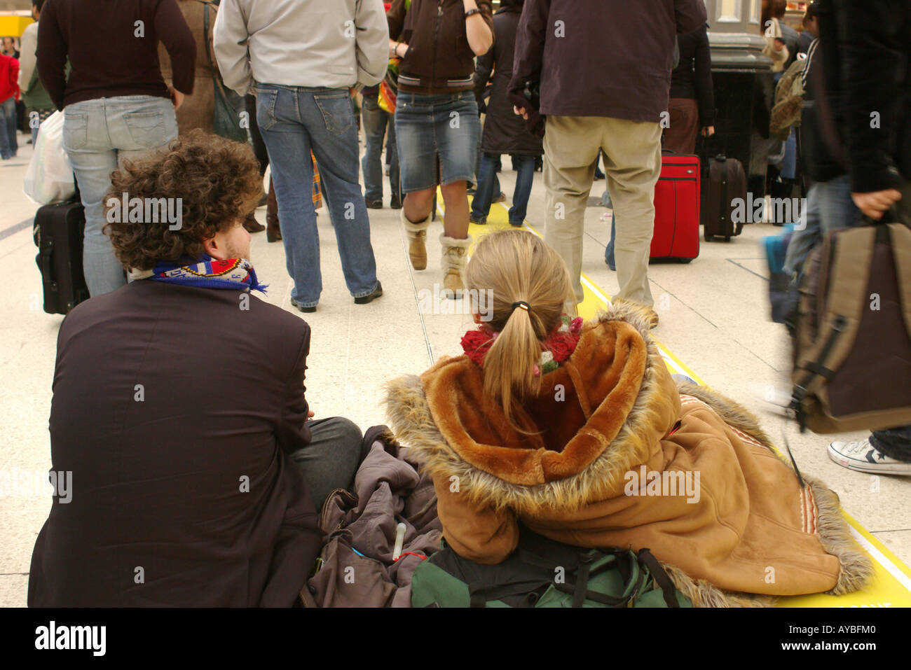A couple waiting for the delayed train for weekend away at London ...