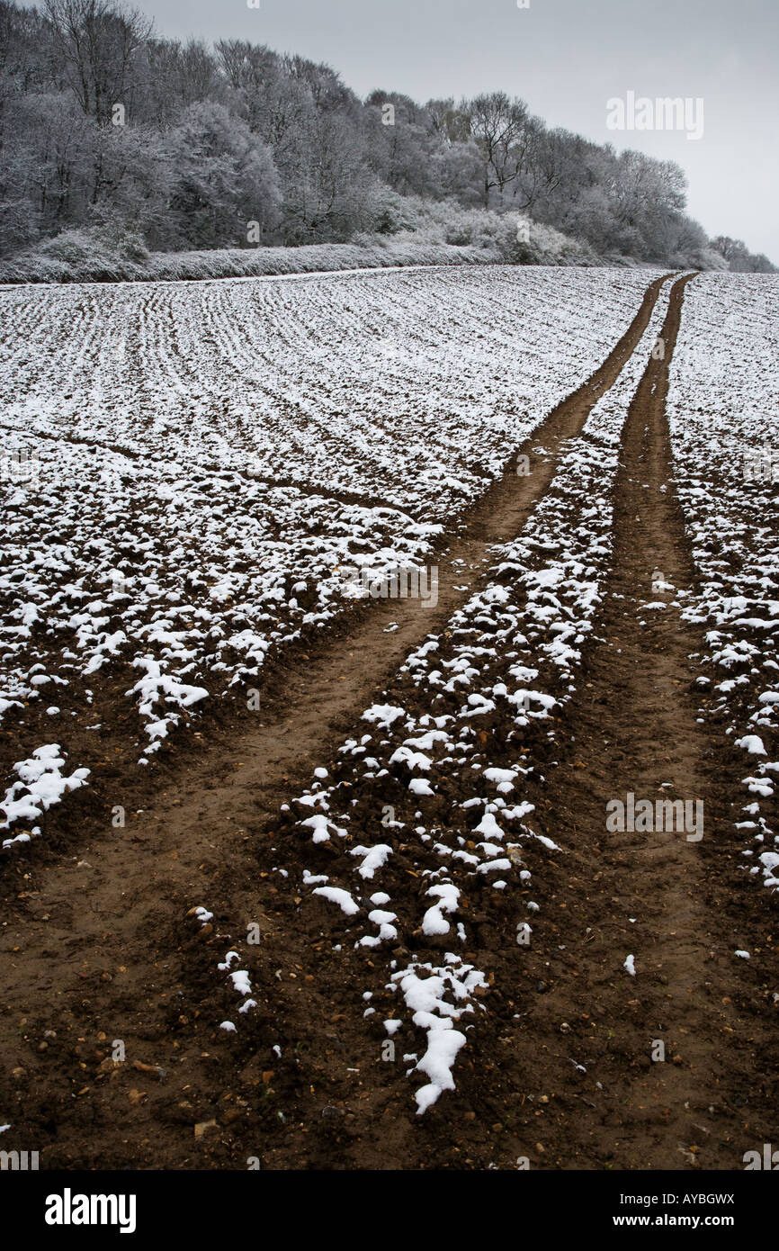 Agricultural farm tracks across a snow covered field in Winter weather ...
