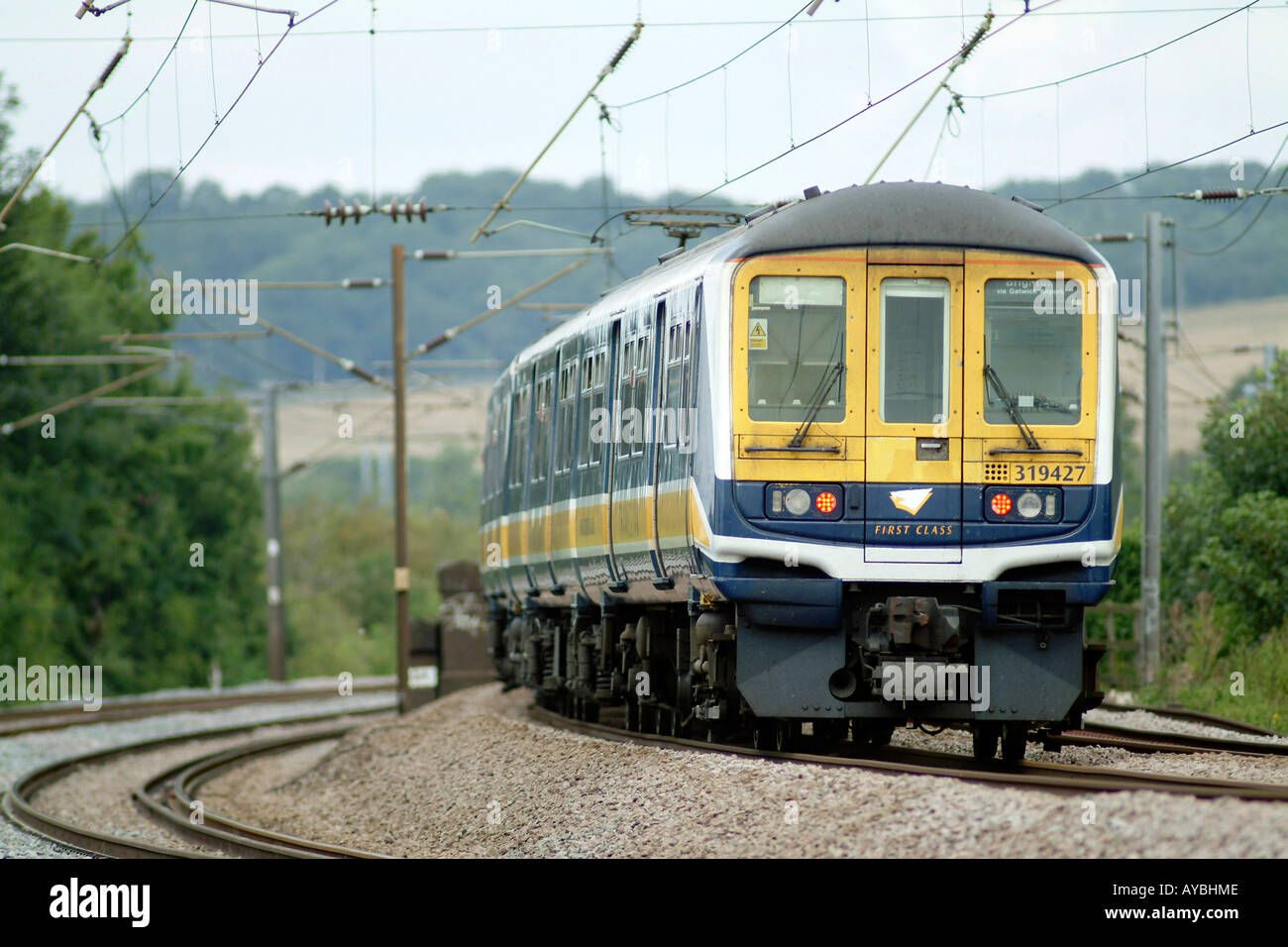 Thameslink class 319 train travelling through the british countryside on the midland mainline ...