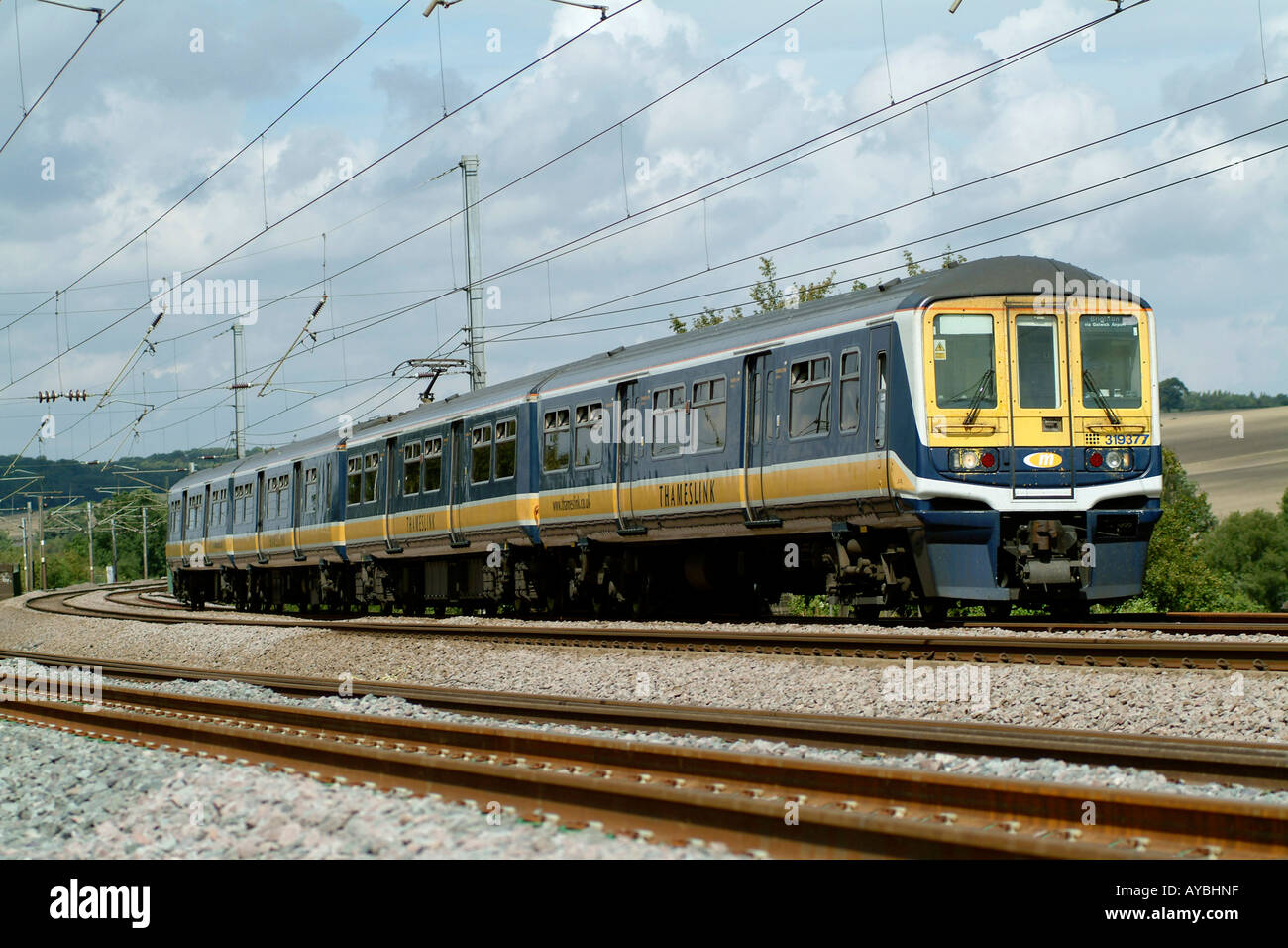 Thameslink class 319 train travelling through the british countryside on the midland mainline ...