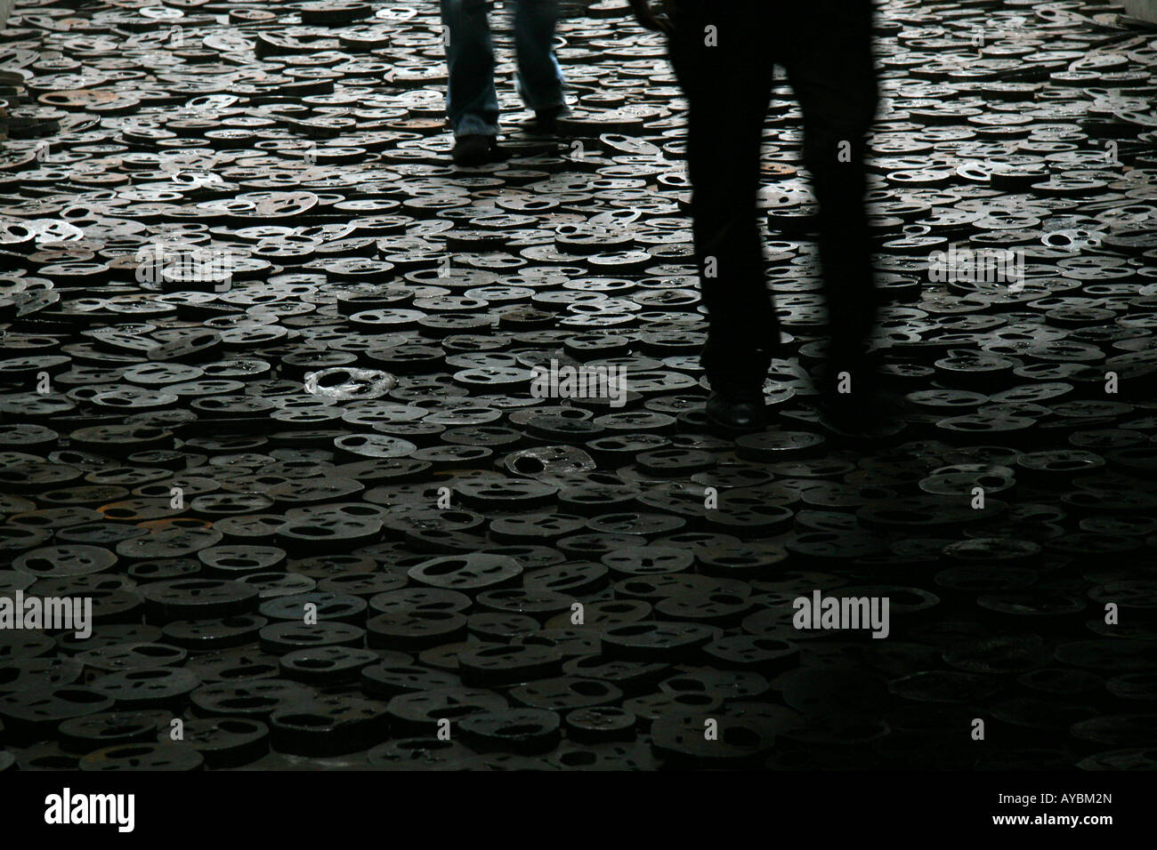 Visitors walking across the Shalechet - Fallen Leaves exhibit, in the ...