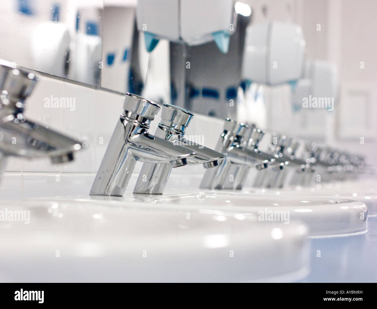 Taps and washbasins in school bathroom Stock Photo - Alamy