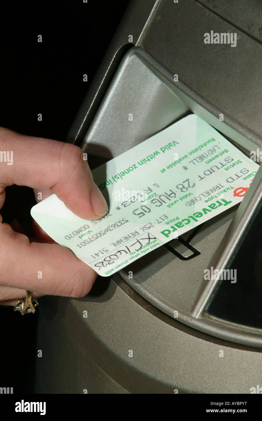 inserting student travel card in a ticket machine at a train station in ...