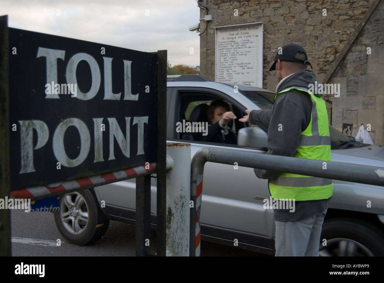 Batheaston Bath BANES UK A motorist pays toll money at the toll bridge ...