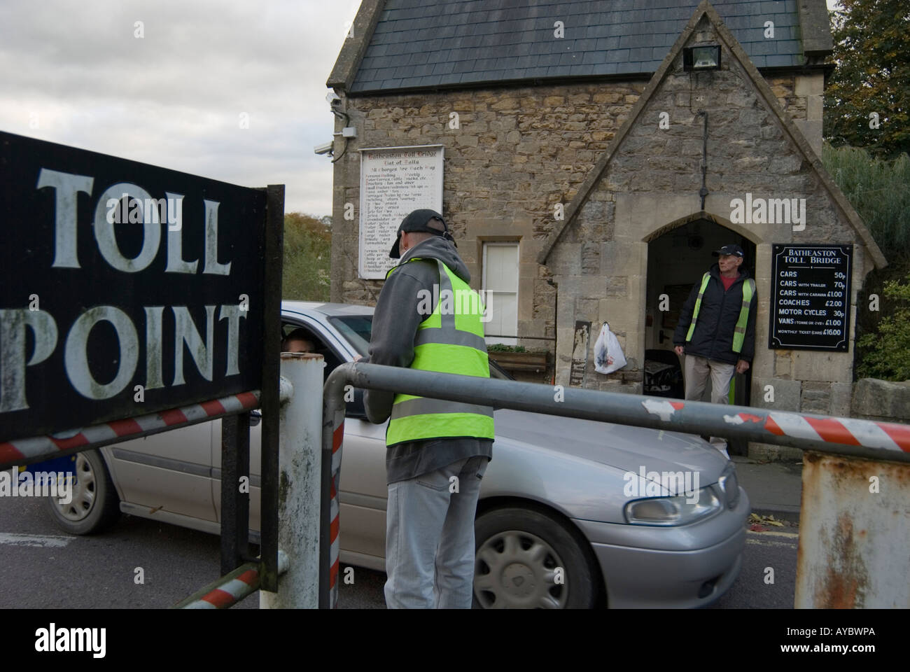 Men collect toll money at the toll bridge over the River Avon at ...