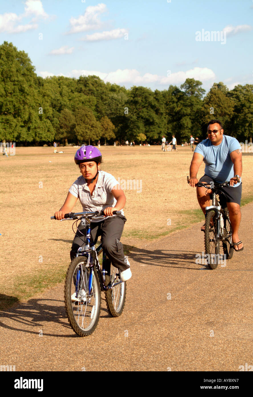 Boy and a man cycling in Hyde Park London Stock Photo - Alamy