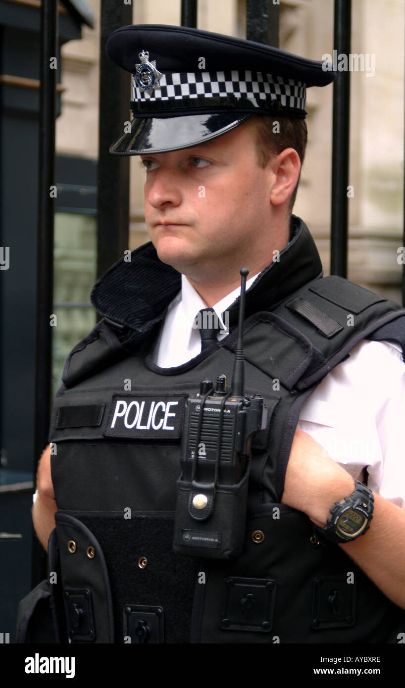 Policeman with body armour and a radio outside Downing Street London ...