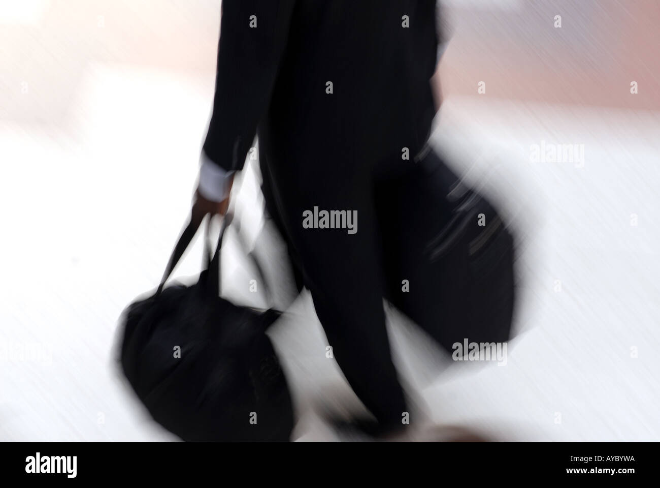 Commuter man at a railway station blurred image Stock Photo - Alamy