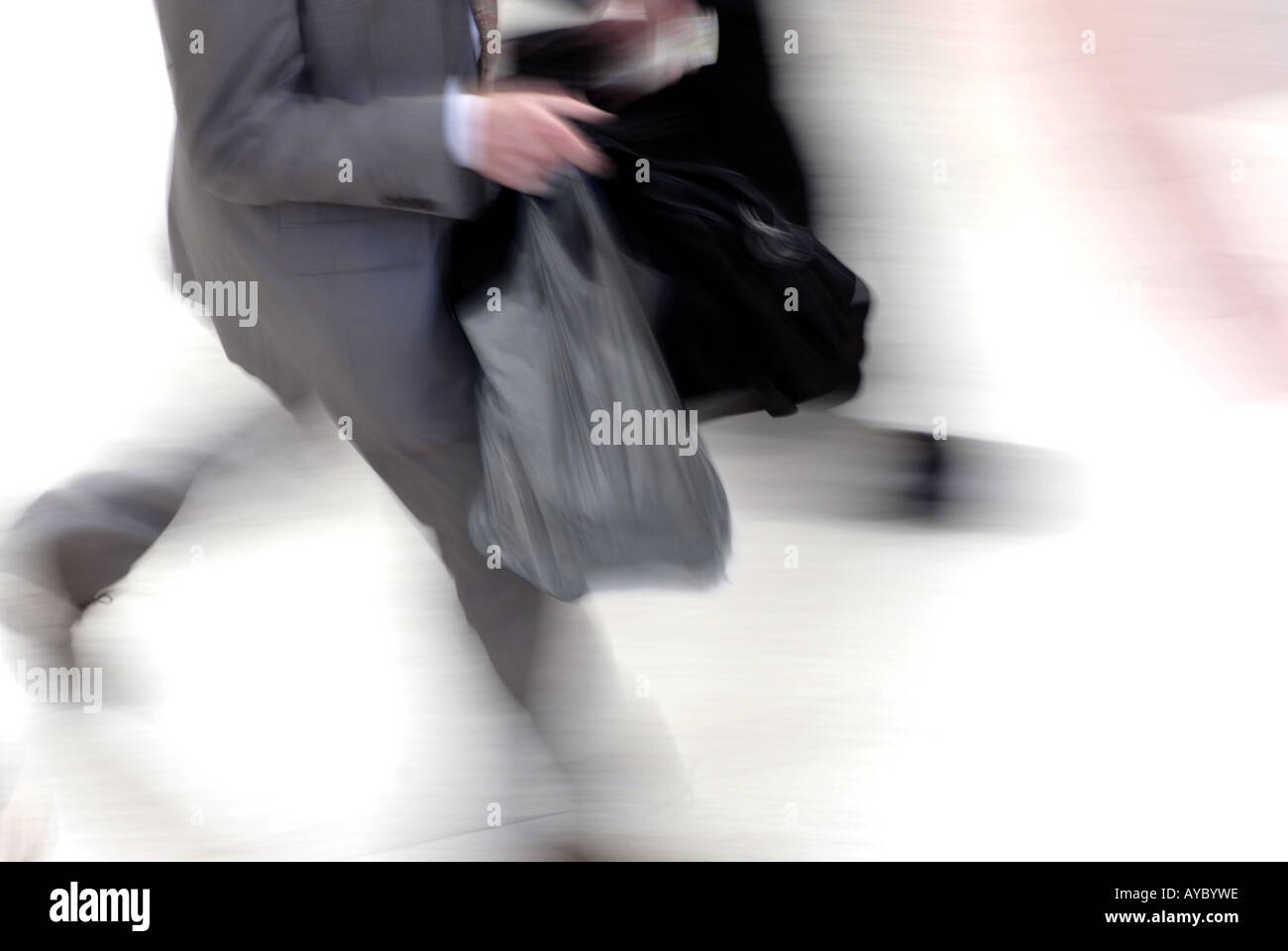 Commuter man at a railway station blurred image Stock Photo - Alamy
