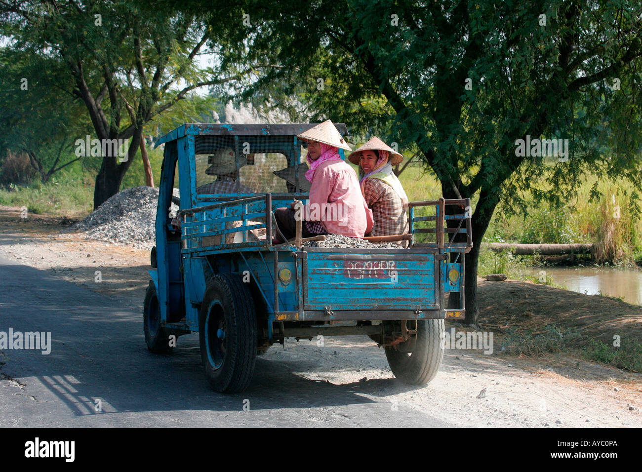 Burmese farm workers travelling on a Chinese Buffalo near Mandalay ...