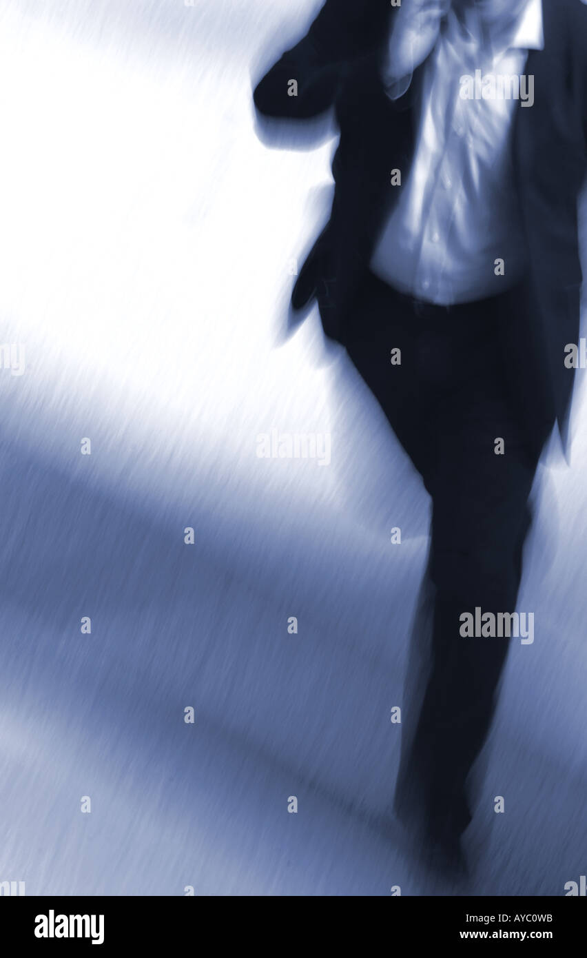 Commuter man on a mobile at a railway station blurred image blue Stock ...