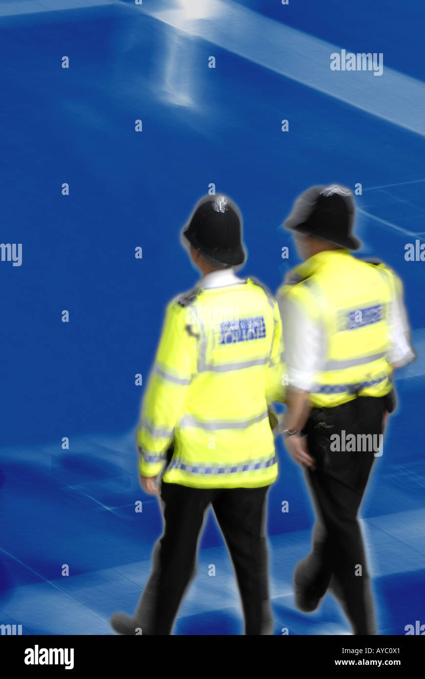 Policemen at a railway station image blue Stock Photo - Alamy