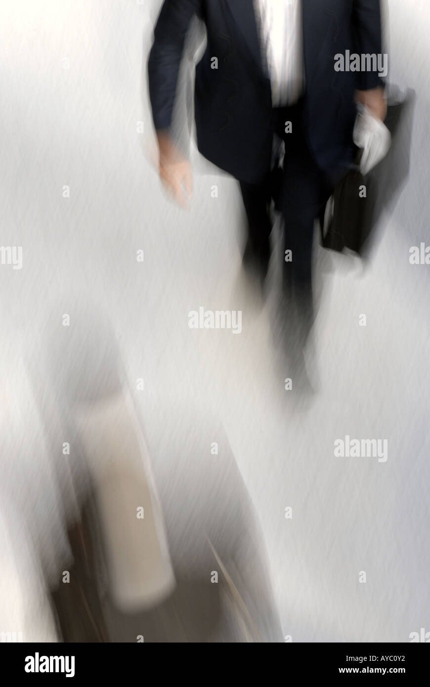 Commuter man at a railway station blurred image Stock Photo - Alamy