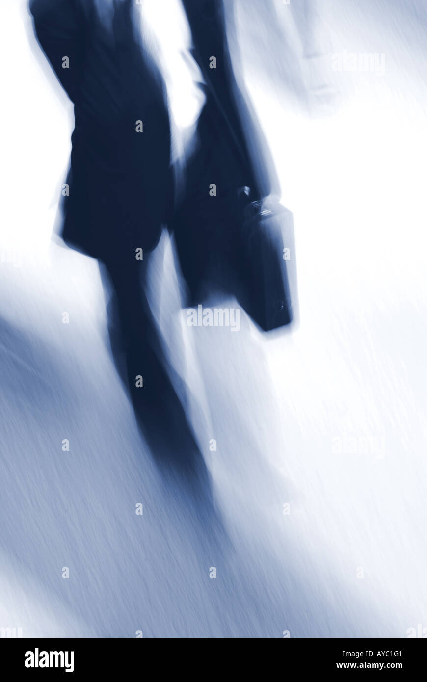 Commuter man at a railway station blurred image blue Stock Photo - Alamy