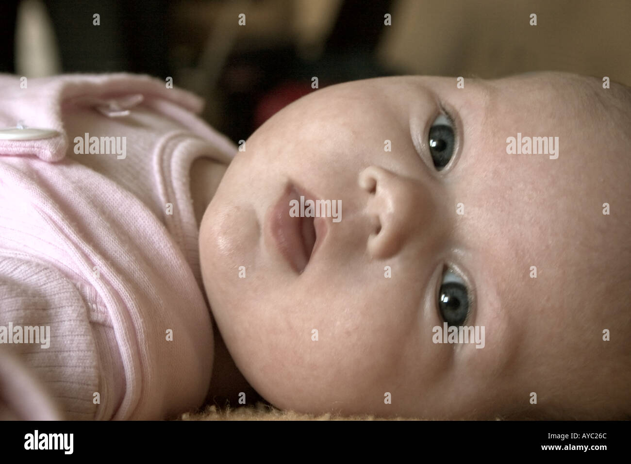 small baby under 1 year old looks while lying down Stock Photo - Alamy