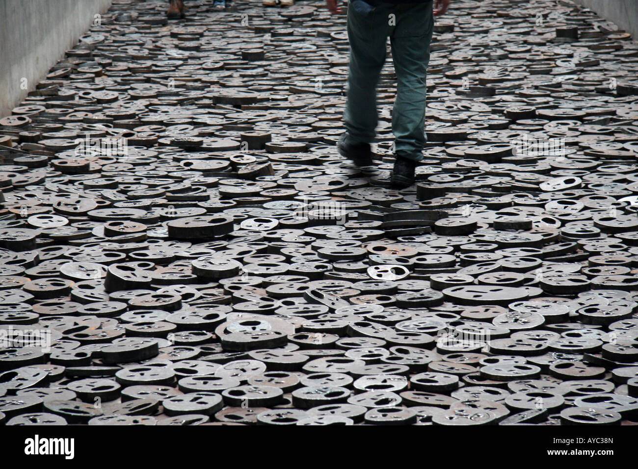 A visitor walks across the Shalechet - Fallen Leaves exhibit, in the ...
