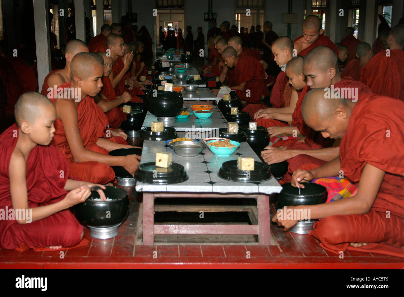 Buddhist monks eating at the Maha Ganayon monastery at Amarapura, near ...