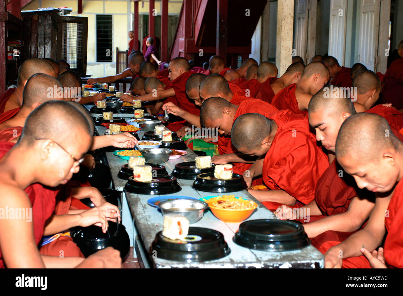 Buddhist monks eating at the Maha Ganayon monastery at Amarapura, near ...