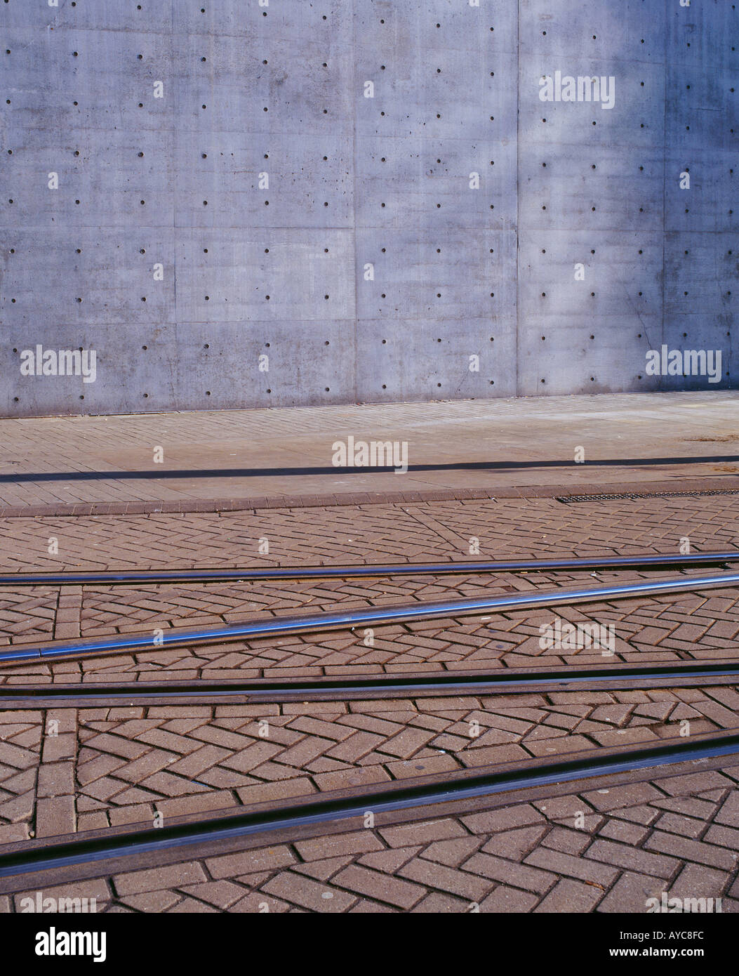 concrete wall and tram lines Stock Photo - Alamy