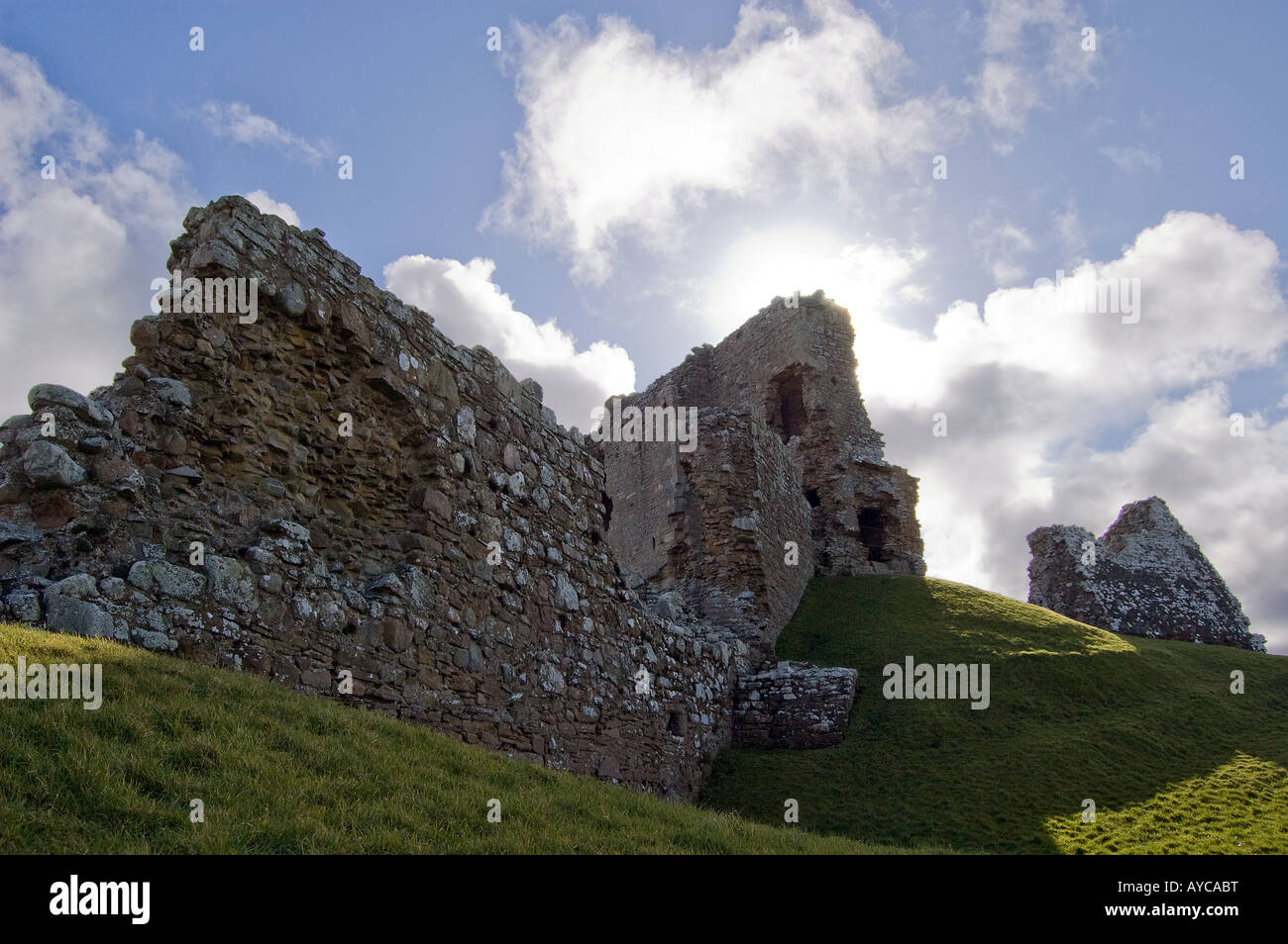The sun bursting through the clouds behind Duffus Castle, Scotland ...