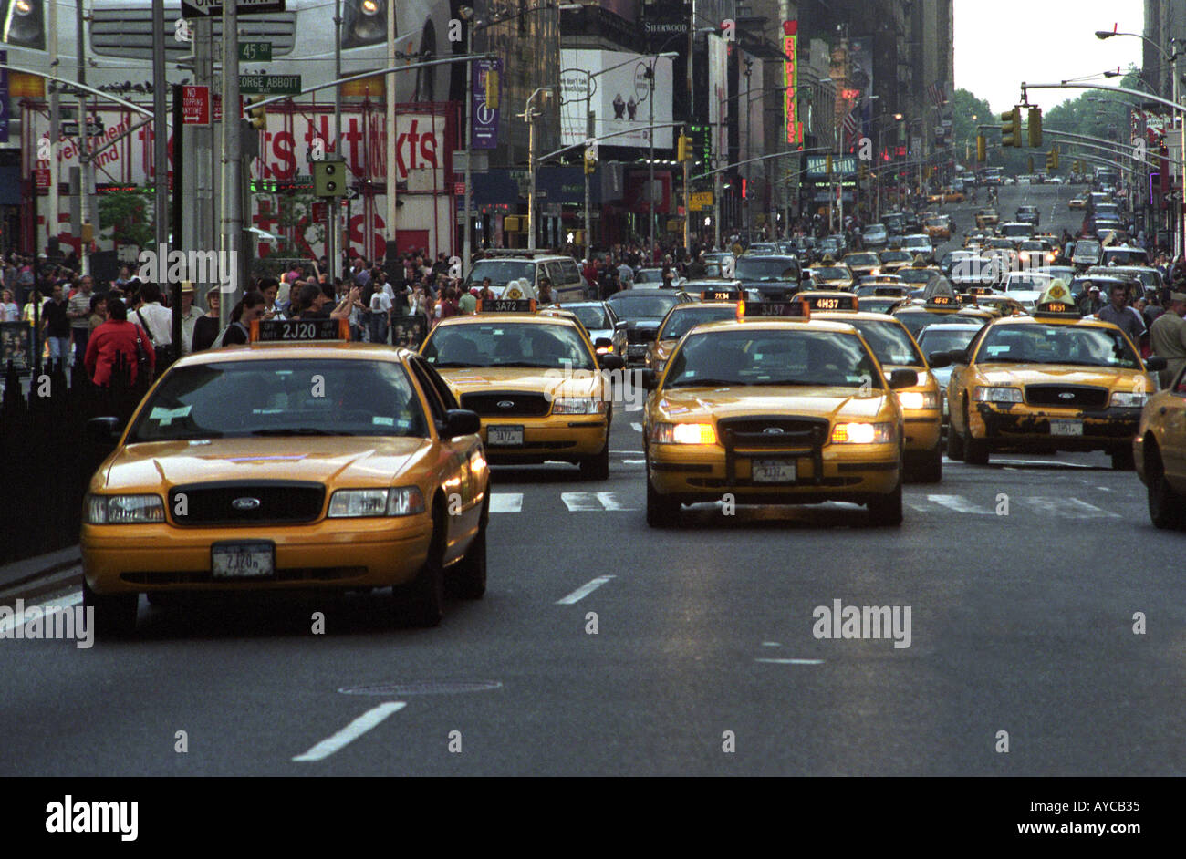 Yellow taxi cabs pass through Times Square in New York City Stock Photo ...