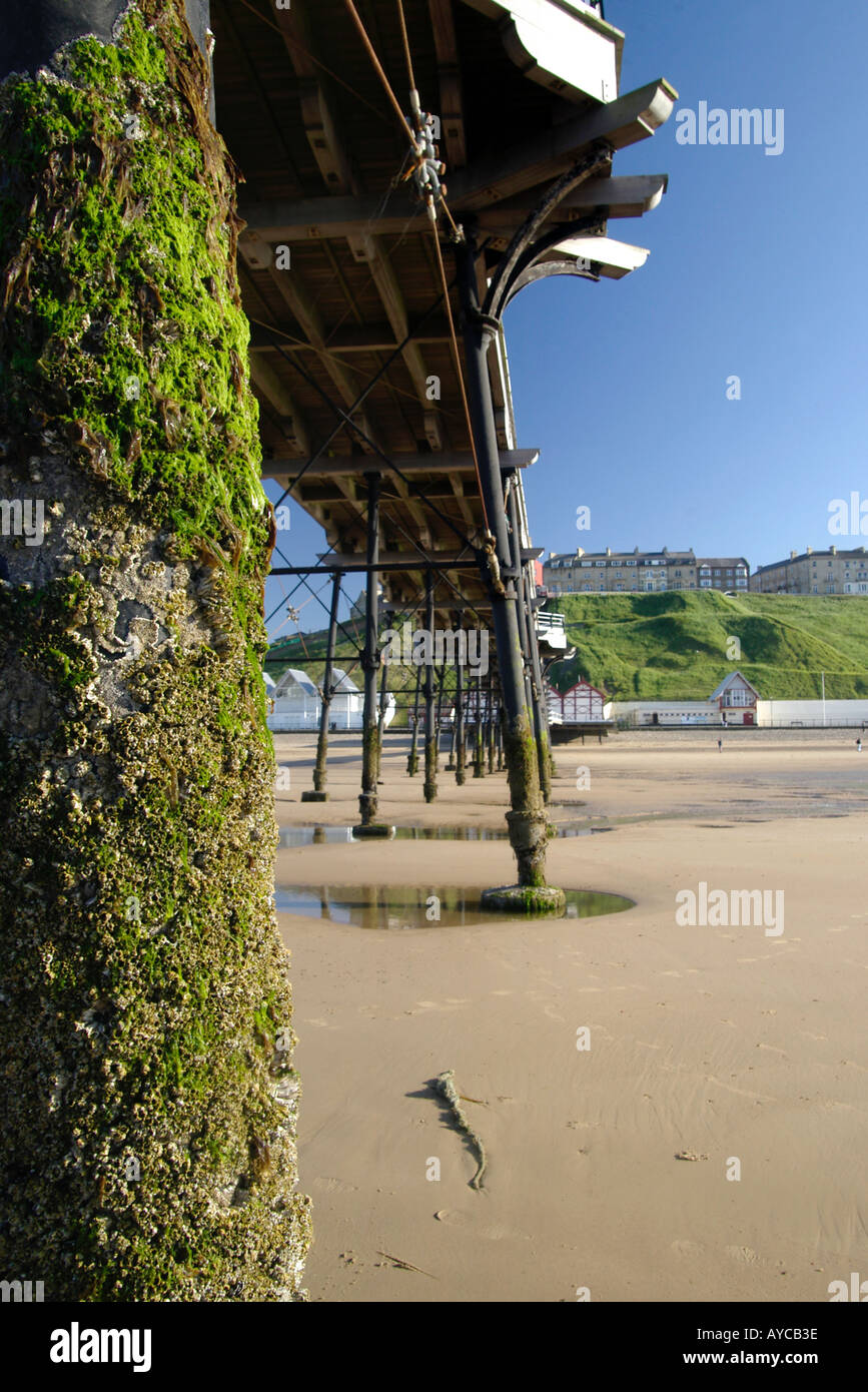Saltburn Victorian paier showing one of the cast iron legs at low tide ...