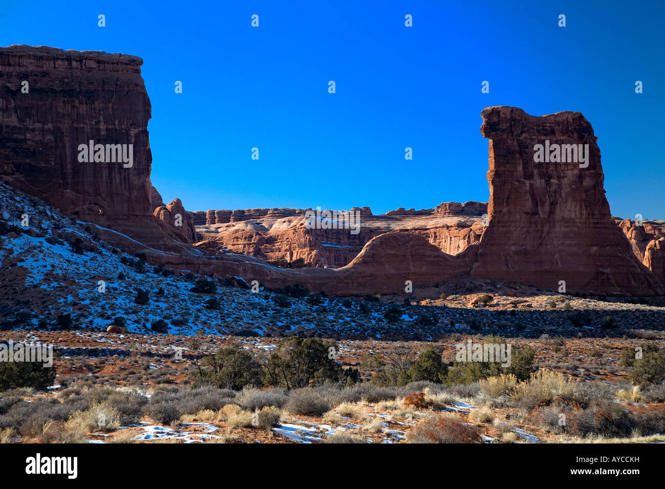Baby and Sheep Rock fallen arch with winter snow at Arches National ...