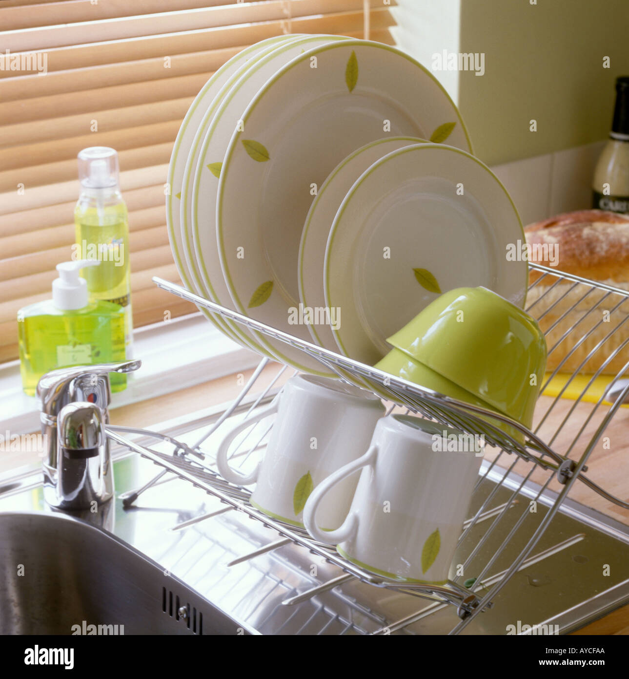 Sink drainer with dishes on rack drip drying Stock Photo - Alamy