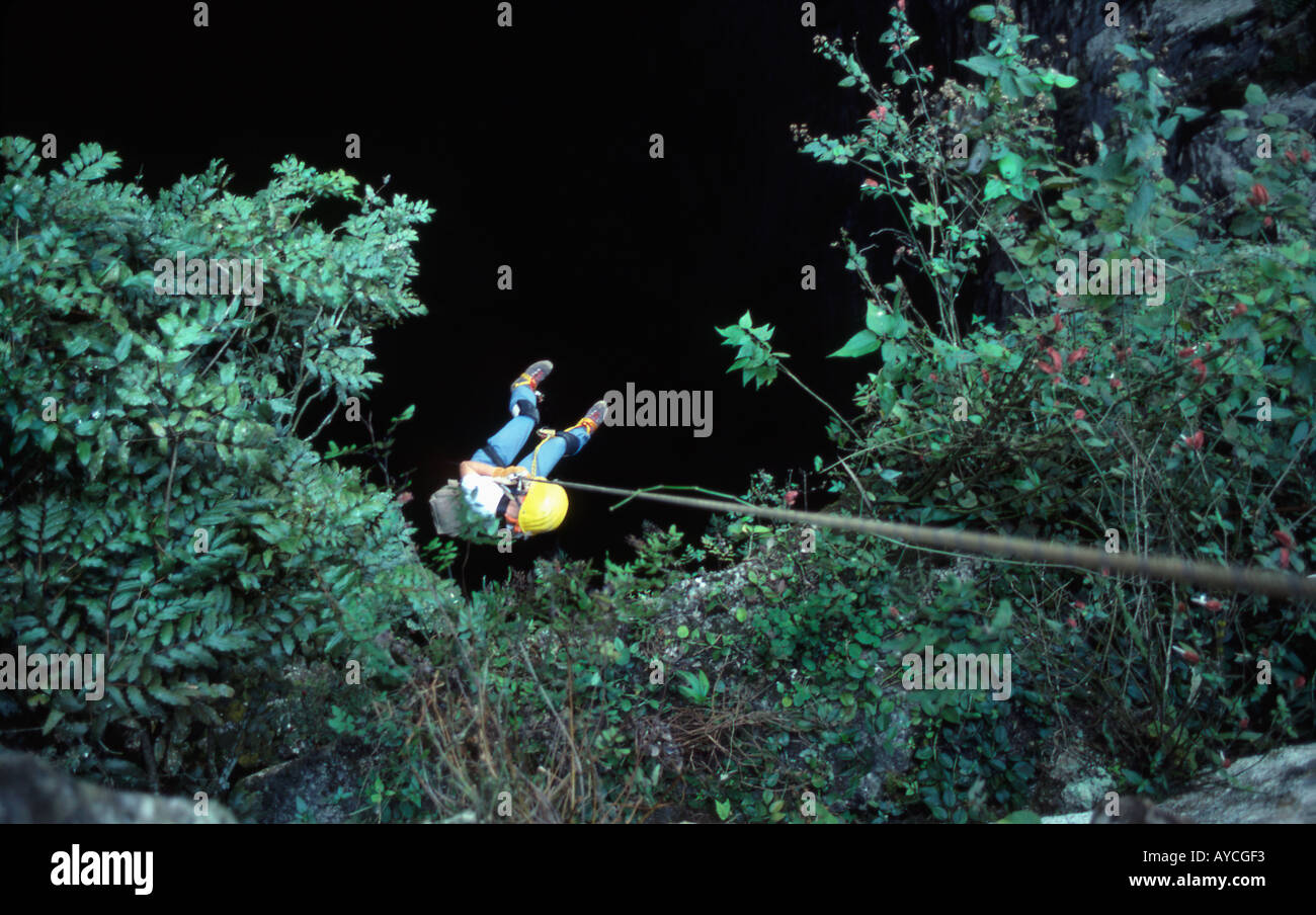 A caver drops into a deep vertical shaft cave Stock Photo - Alamy