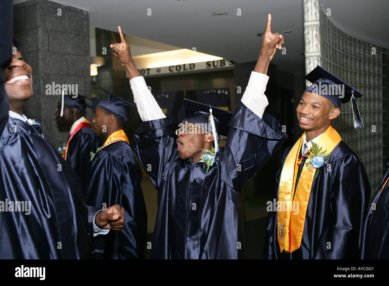 High school student reacts with joy as he is about to begin graduation ...