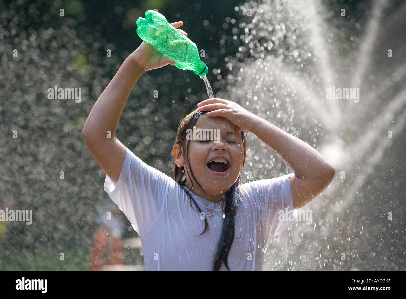 Children pouring water over head hi-res stock photography and images ...