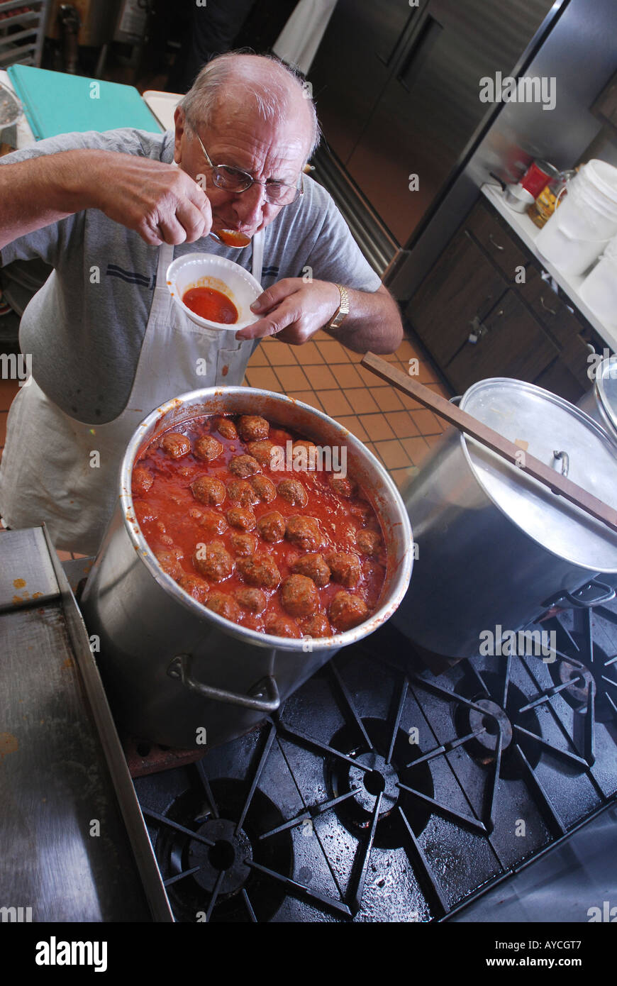 Italian Chef Cooking Massive pot of meatballs and tomato sauce Stock ...
